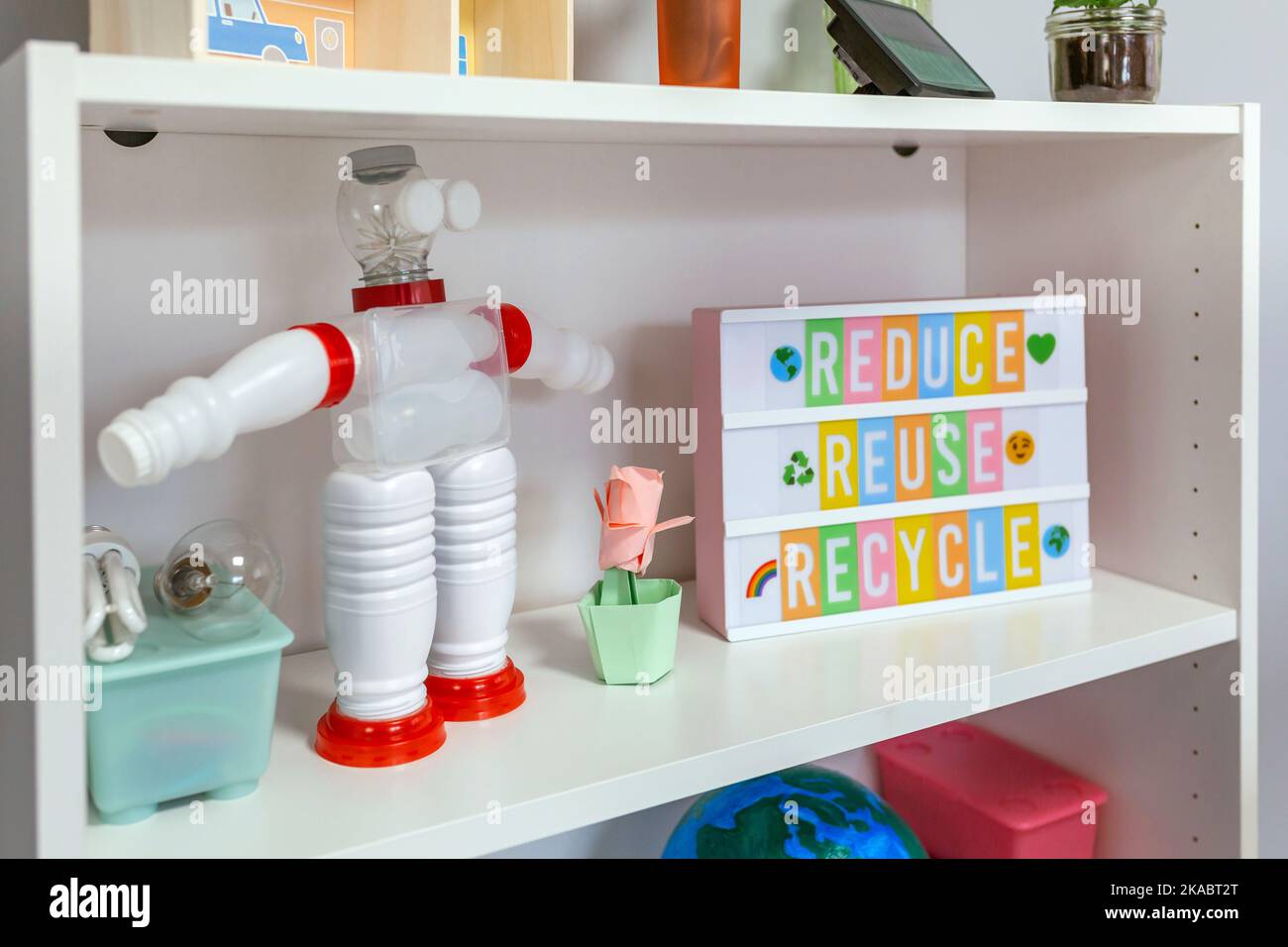 Recycled toy robot made with plastic packages and lightbox with ecology ...