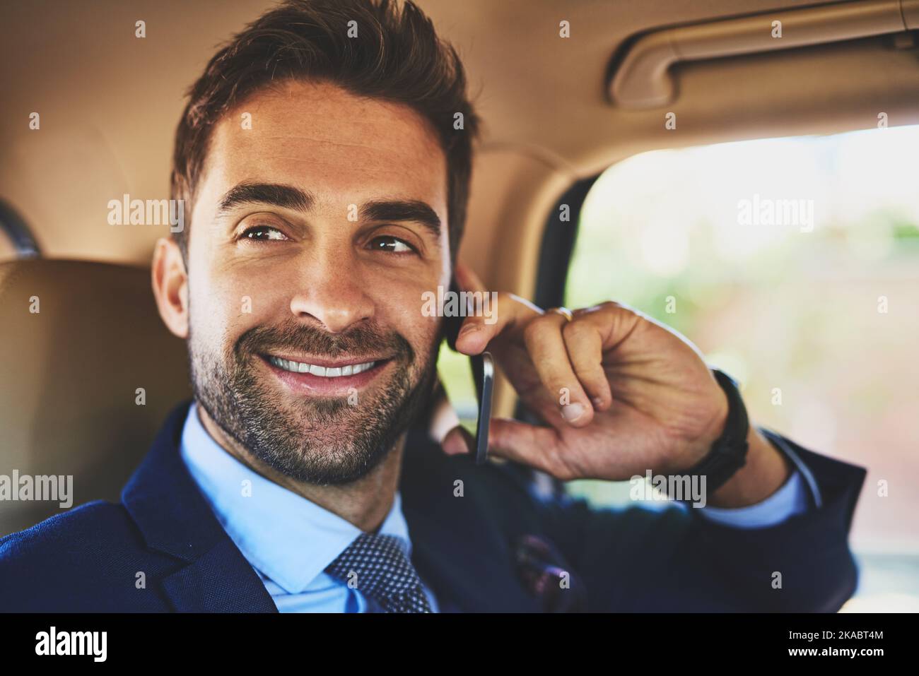 He made his success on his own. a cheerful young businessman talking on ... He made his success on his own. a cheerful young businessman talking on ...