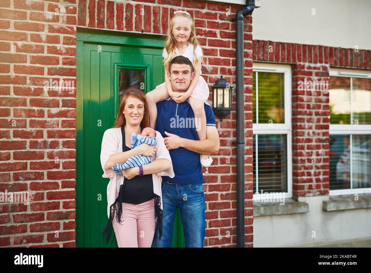 We are all we need. Portrait of a cheerful young family grouped ...