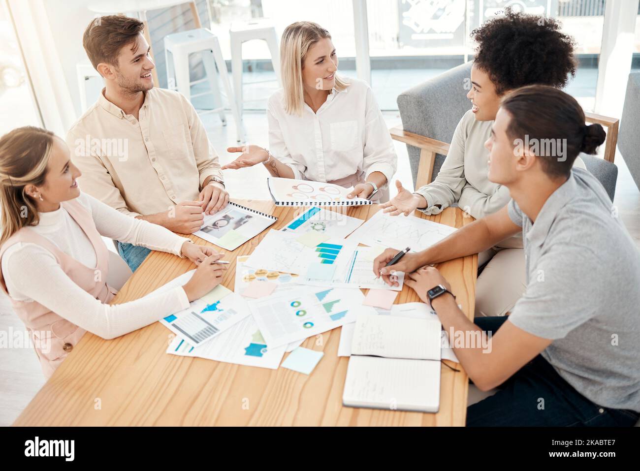 Documents, graphs and business people in meeting for analysis, talking and planning. Teamwork ...