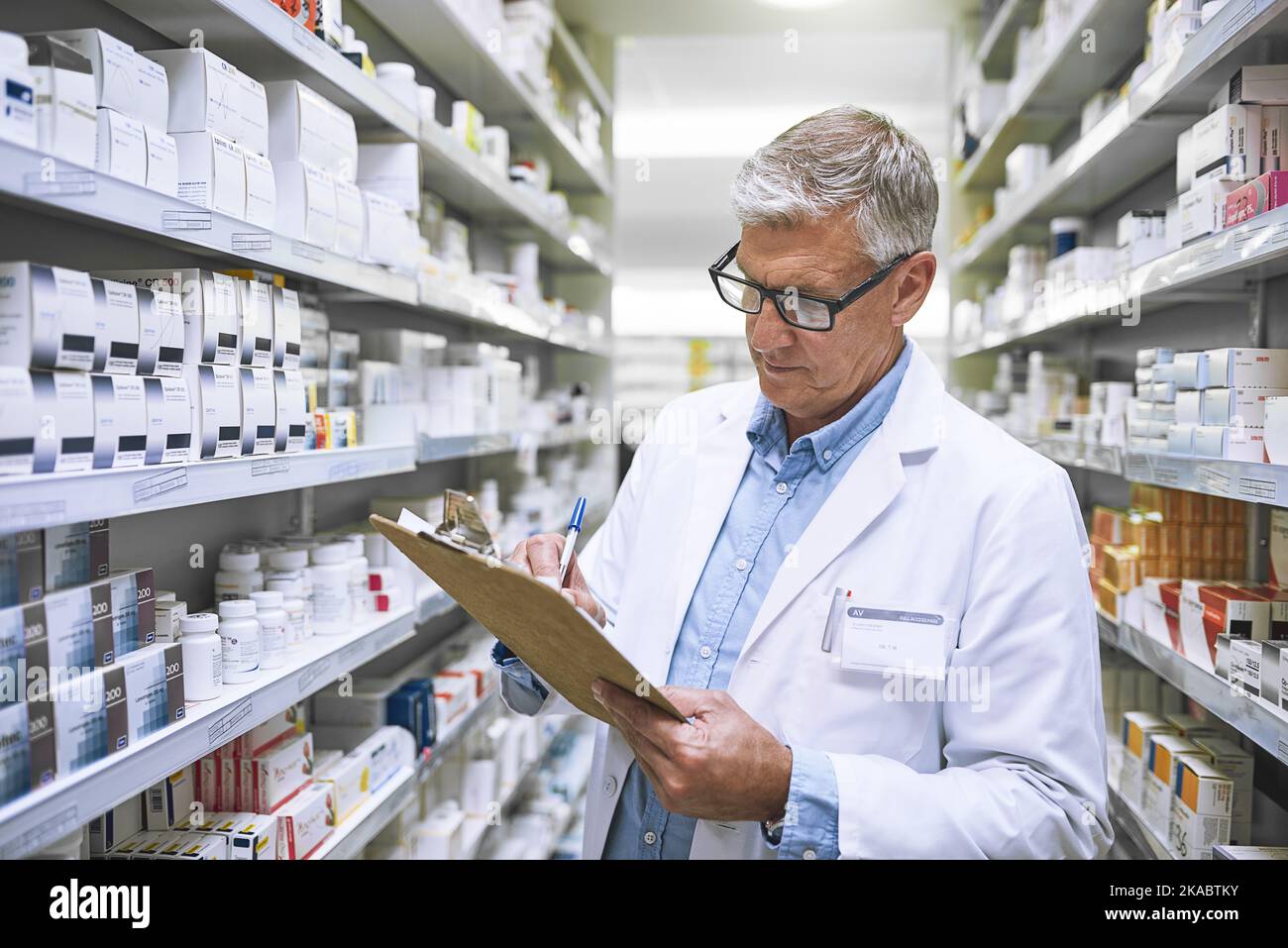 I have to write all of this down. a focused mature male pharmacist ...