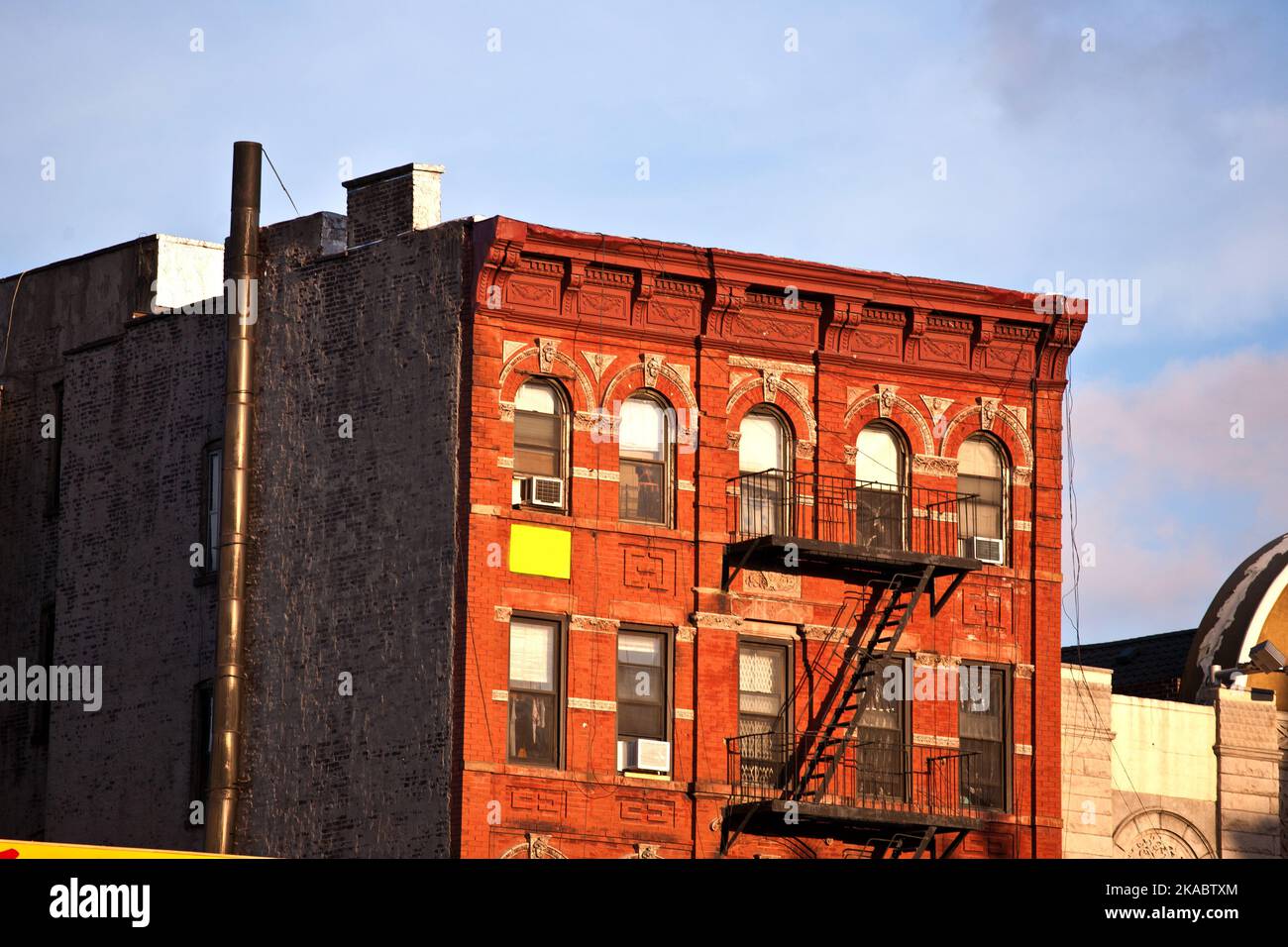 old iron fire escape rescue ladders at old houses in beautiful light ...