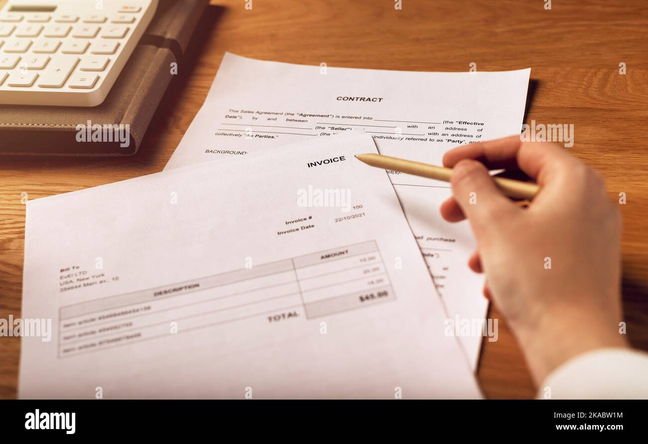 Reading and checking paper invoice and contract concept. Business bill ...