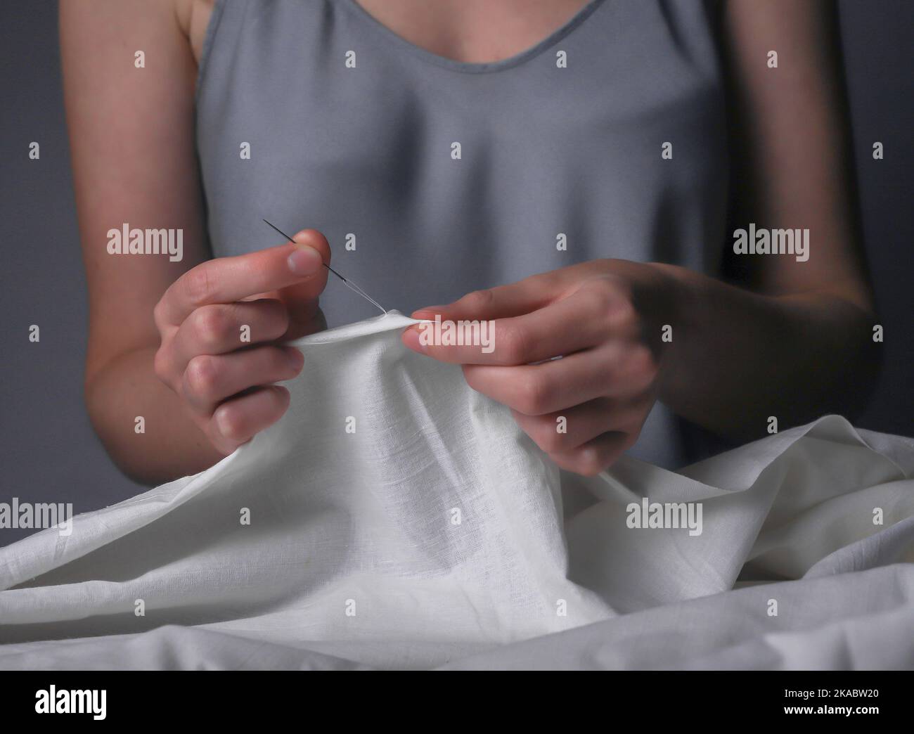 Manual sewing with needle, thread and natural textile Stock Photo - Alamy