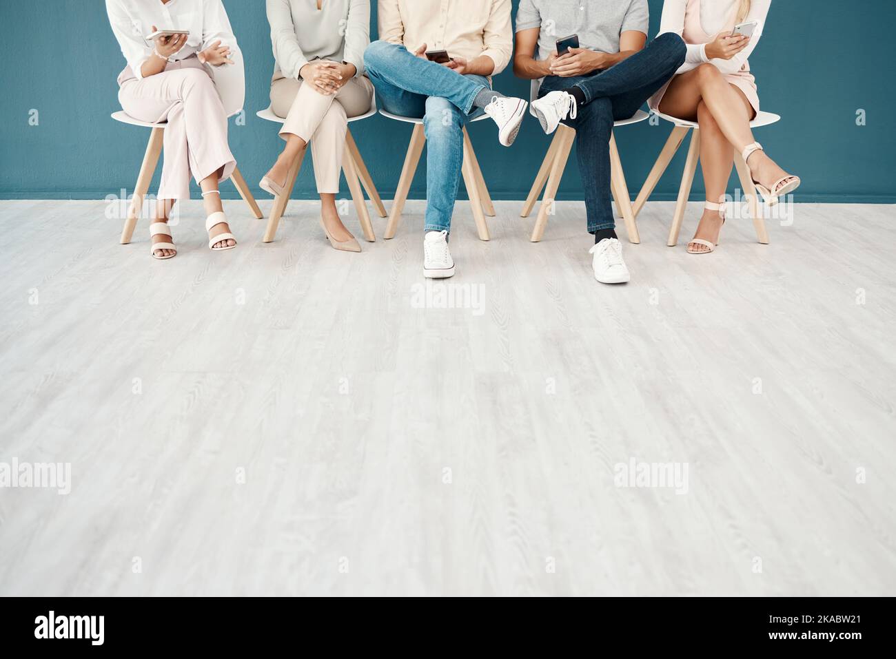 Feet, team and business people sitting in the office waiting for job ...