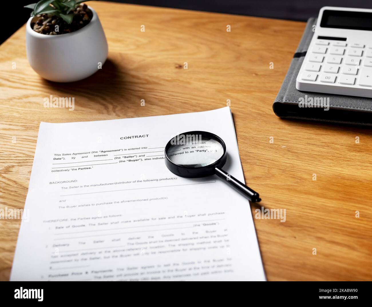 Paper contract on woode desk with magnifying glass Stock Photo - Alamy