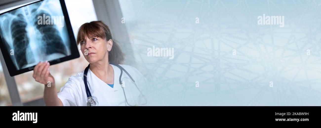 Female doctor examining x-ray report in medical office; panoramic ...