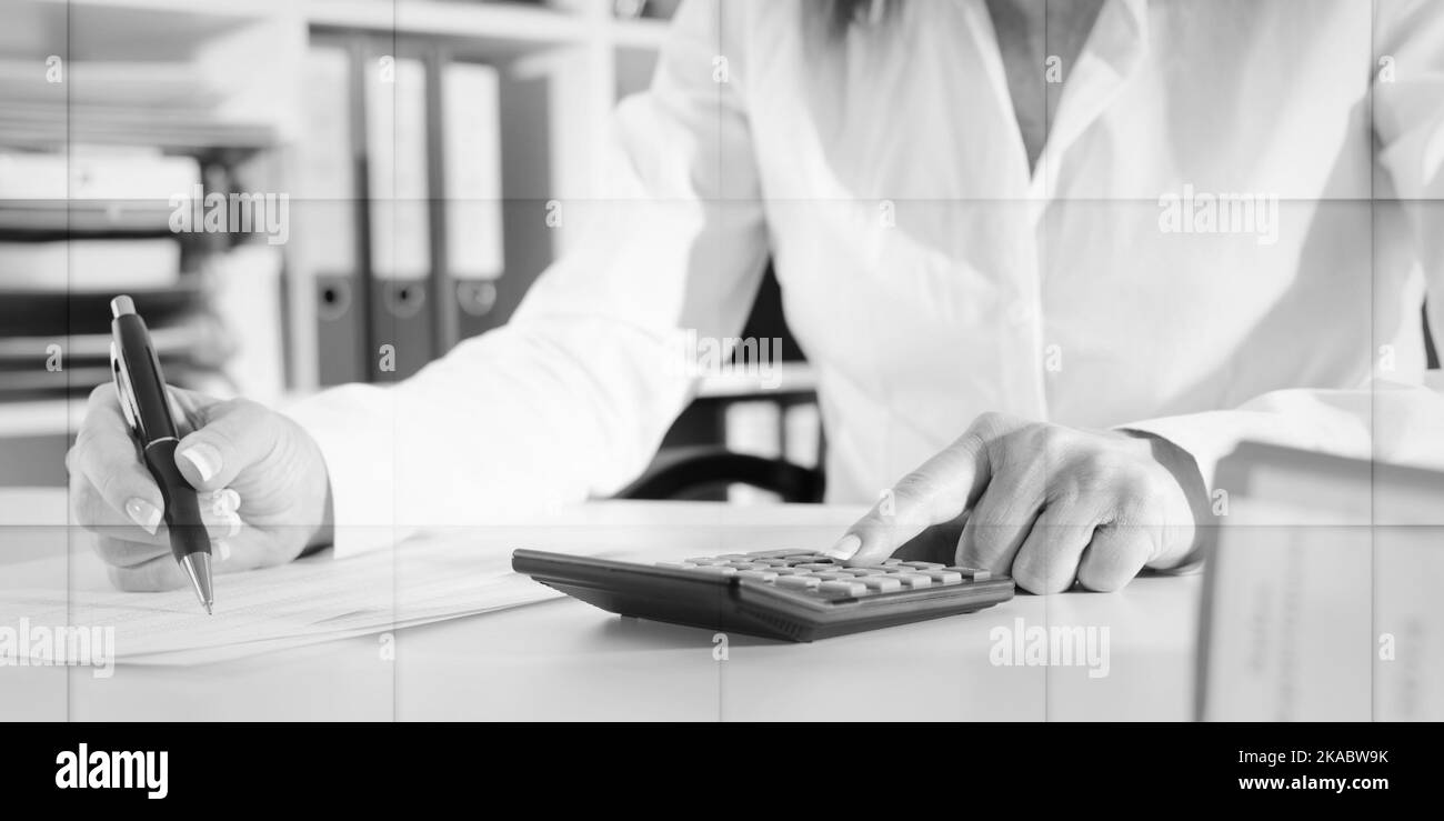 Calculating on office desk Black and White Stock Photos & Images - Alamy