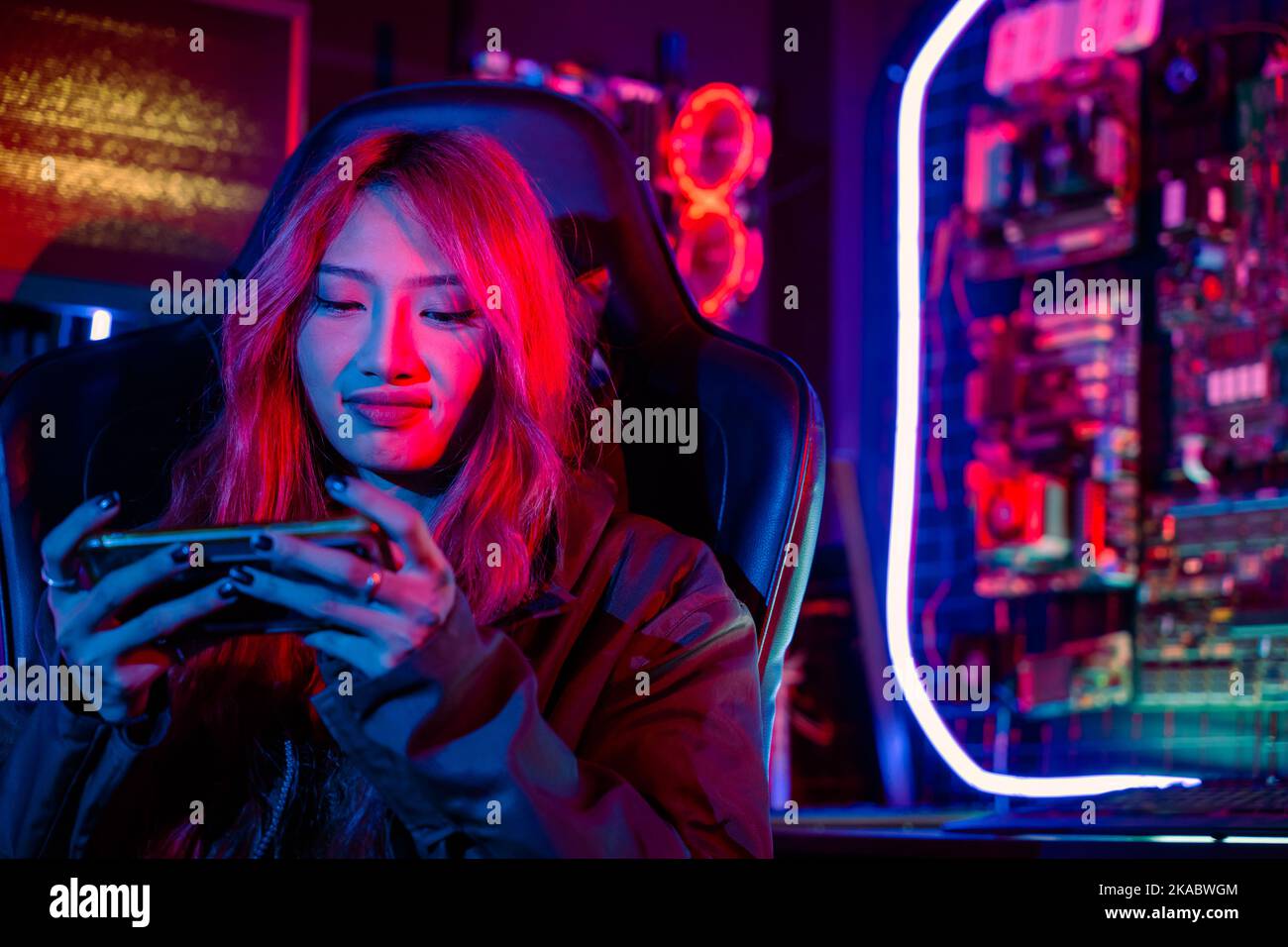 woman live stream she play video game at home neon lights living room ...