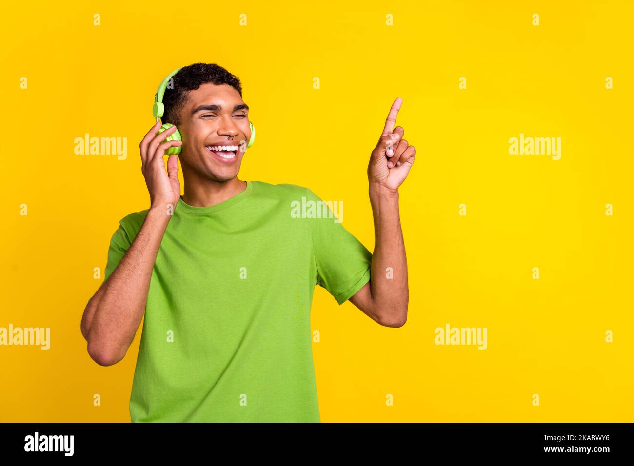 Photo portrait of handsome young man touch earphones have fun enjoy ...
