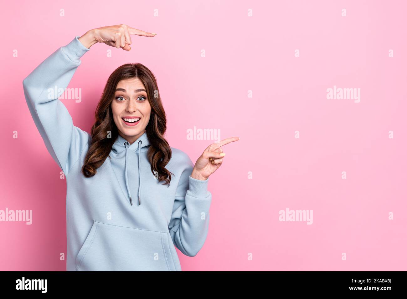 Photo of positive pretty girl beaming smile indicate fingers empty ...