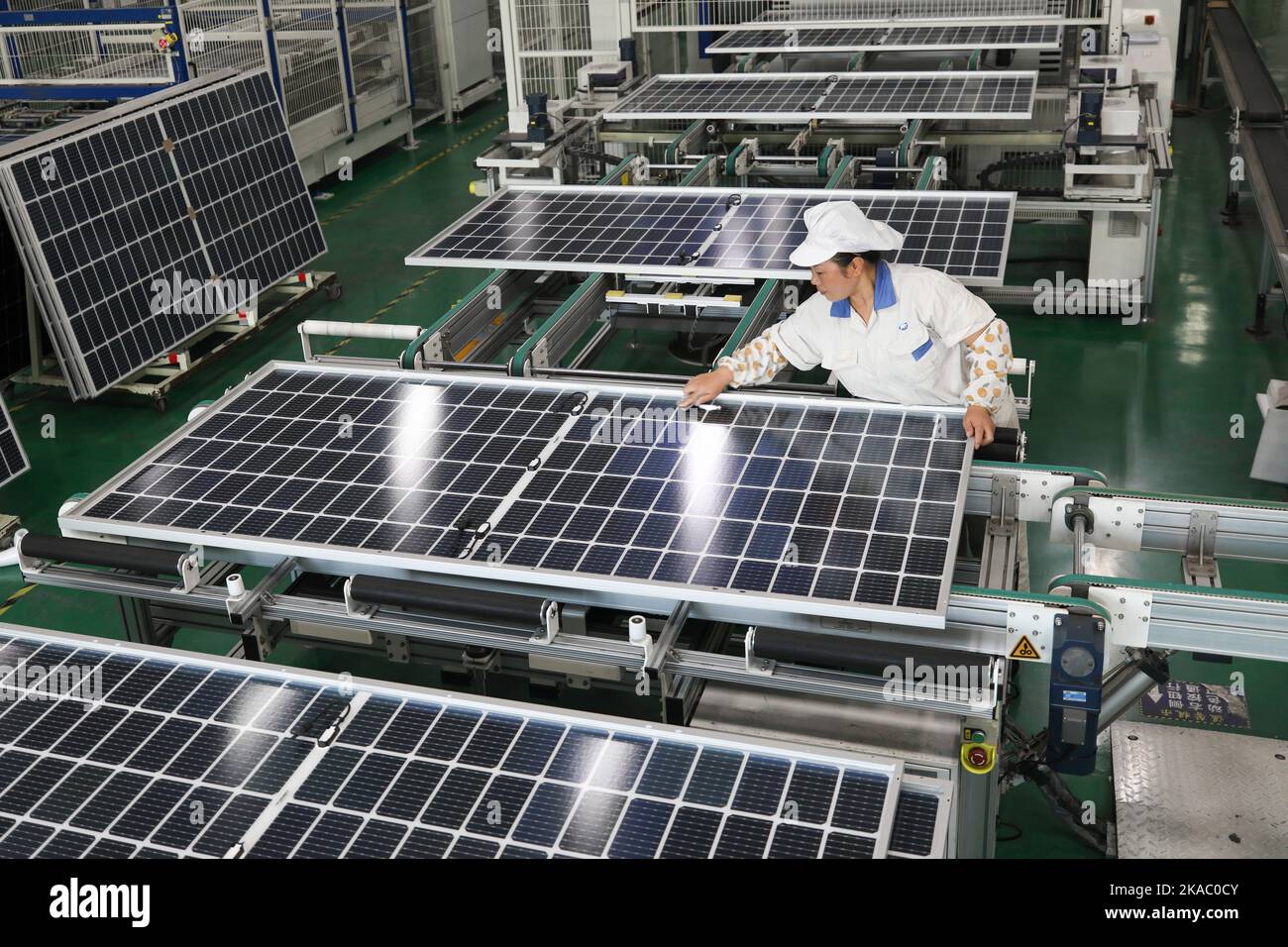 Workers are busy manufacturing the export solar photovoltaic panels in ...