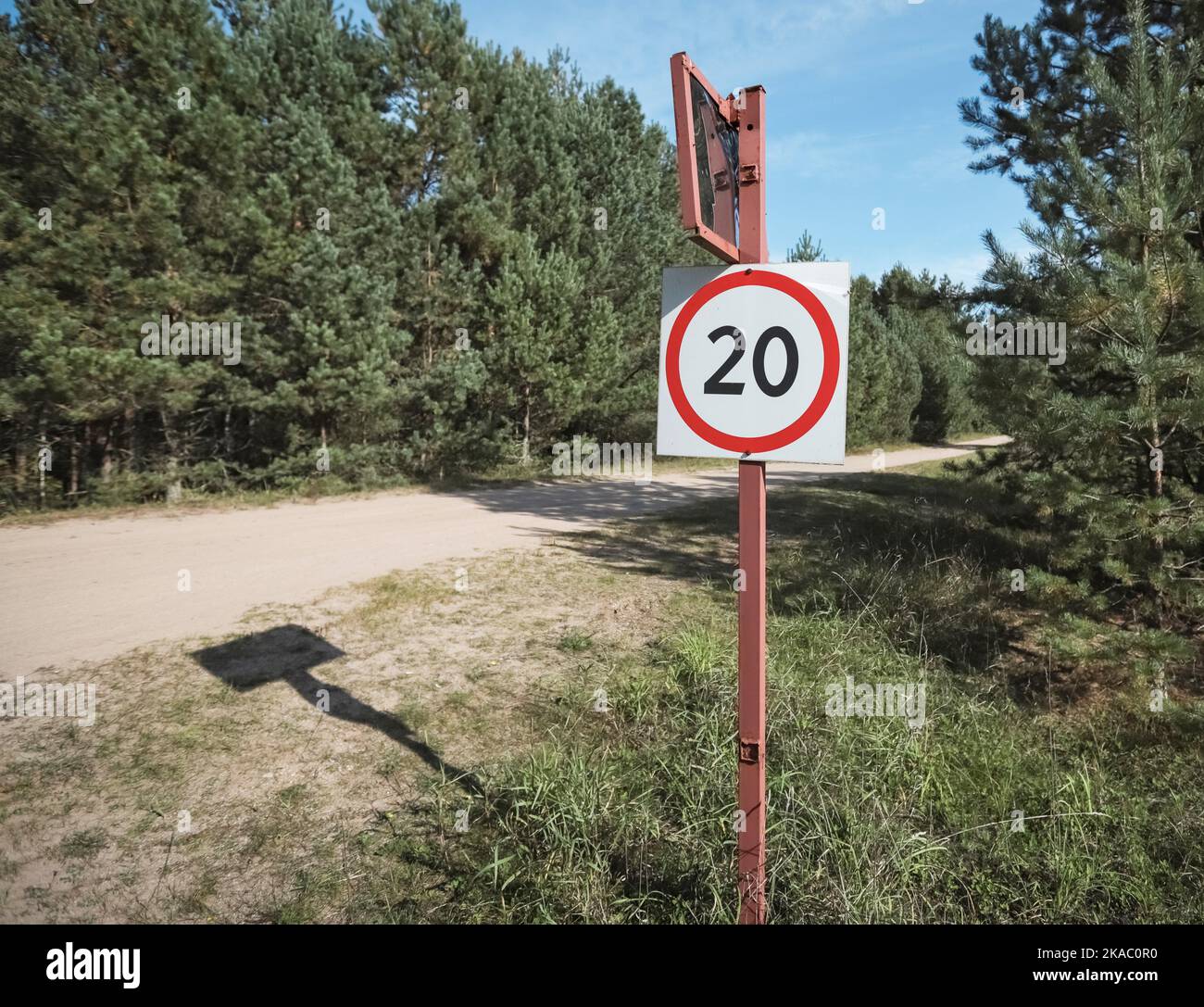 20 Km Per Hour Speed Limit Sign Near Ground Road In Nature Stock Photo 20-km-per-hour-speed-limit-sign-near-ground-road-in-nature-stock-photo