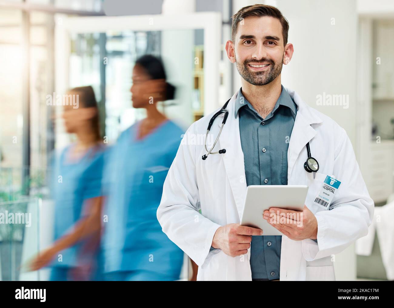 Healthcare, confidence and doctor with tablet in busy hospital with ...