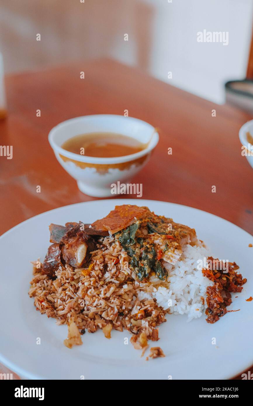 Vertical or Portrait shot of a plate of Nasi Babi Guling or Pork Roll ...