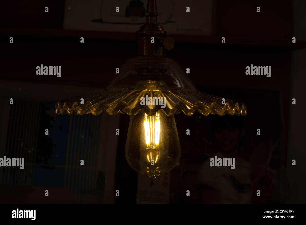 Vintage look of modern filament led bulb with transparent cover in a ...