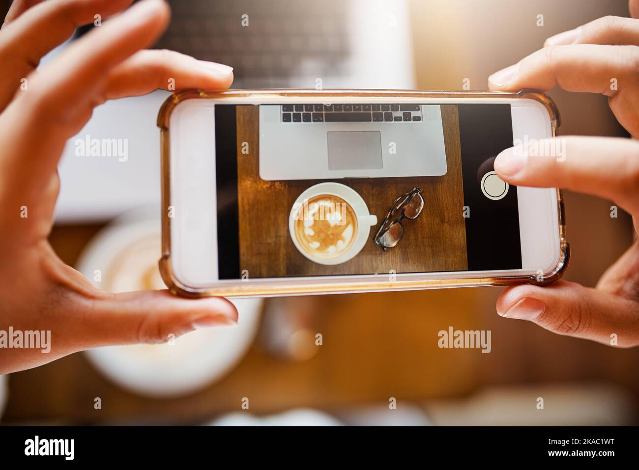 This should do the trick. a unrecognizable woman taking a picture with her cellphone of a cup ...