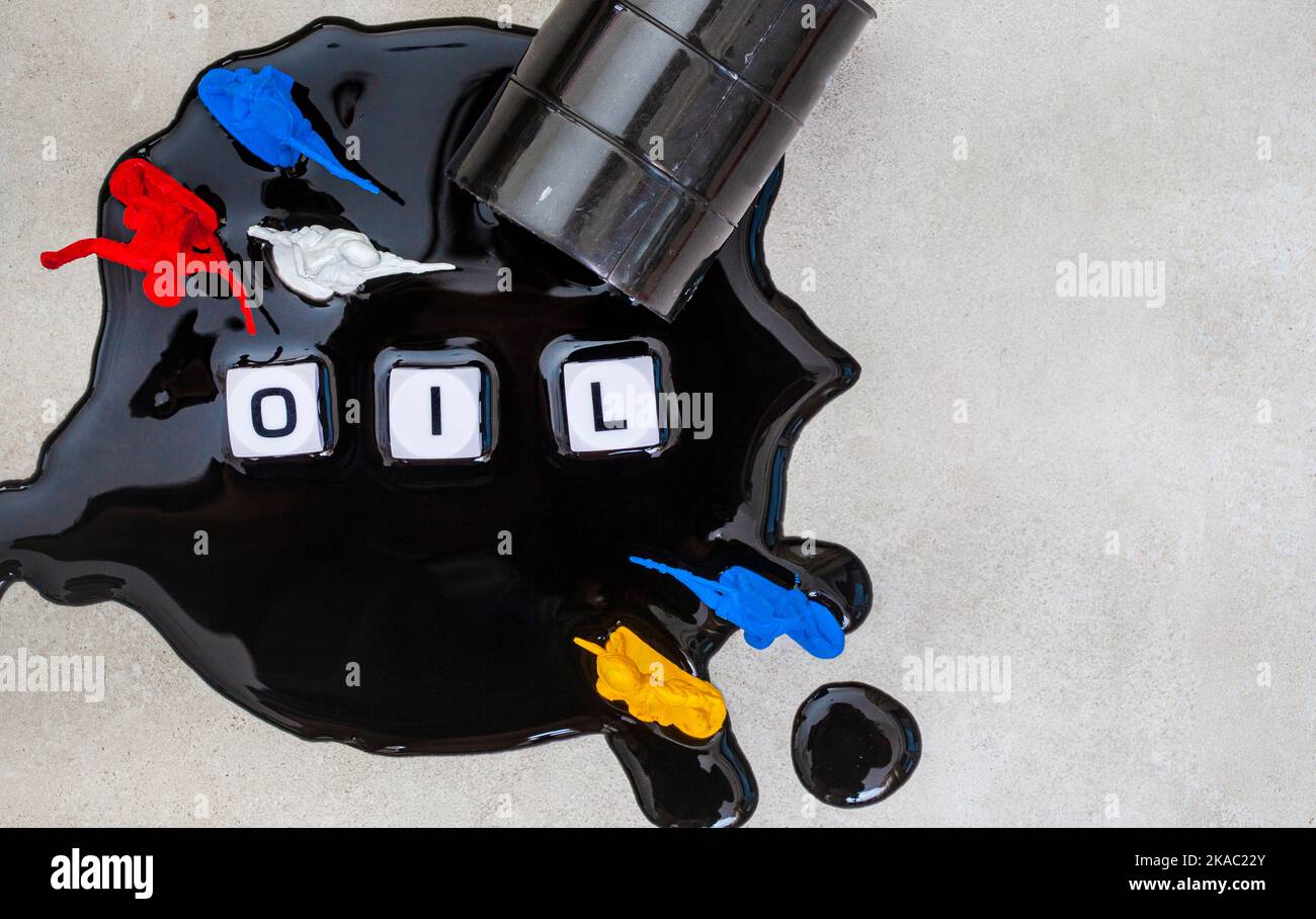 Oil crisis depiction with toys, oil barrel and spill on gray with ...