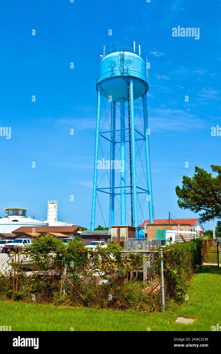 A blue watertower against a blue cloudy sky Stock Photo - Alamy