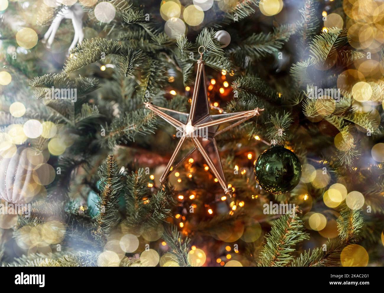 Christmas background with blurred Xmas lights and holiday gold star ...