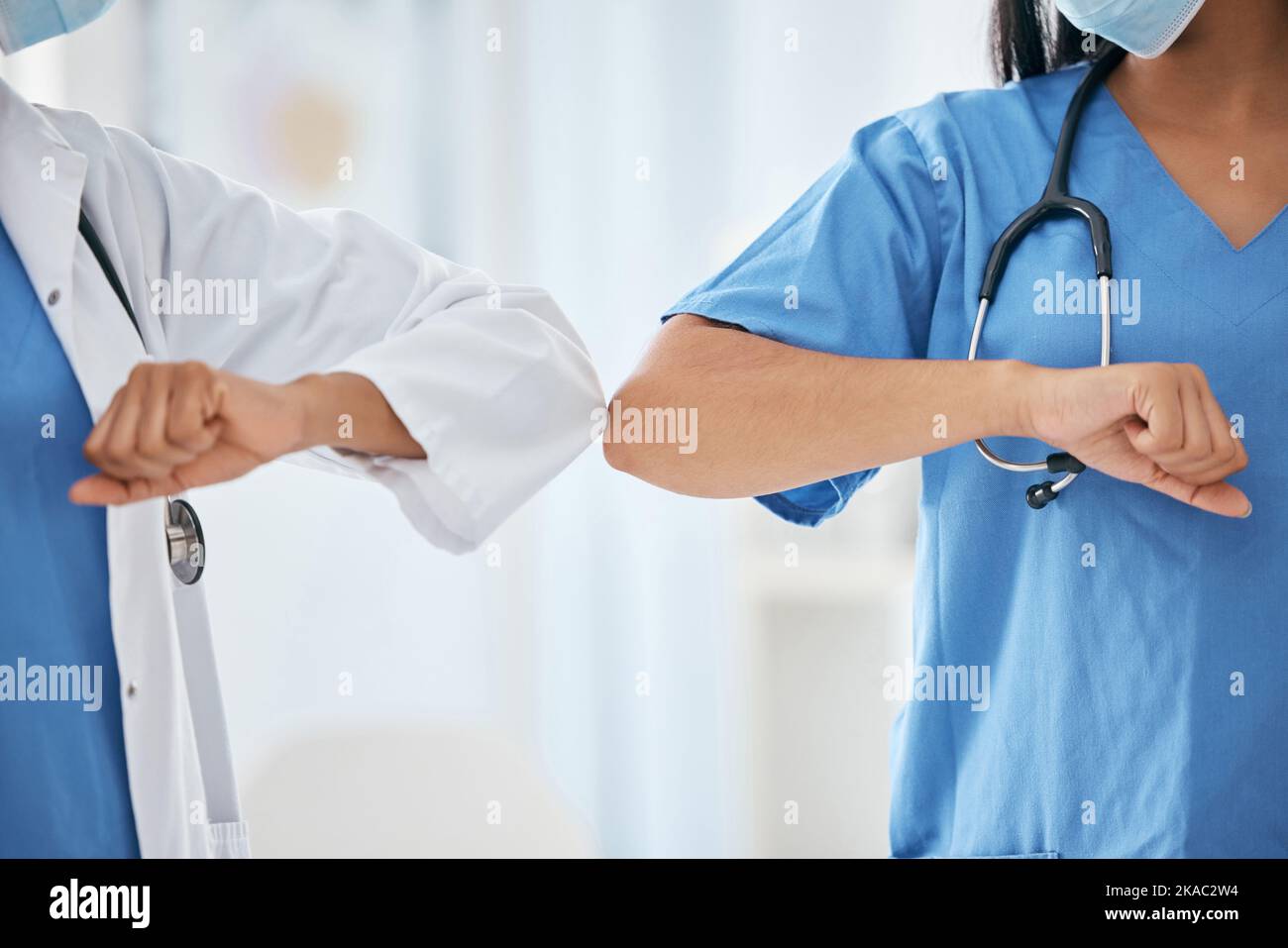 Covid doctor greeting elbow, closeup hospital and ppe work clothes for ...