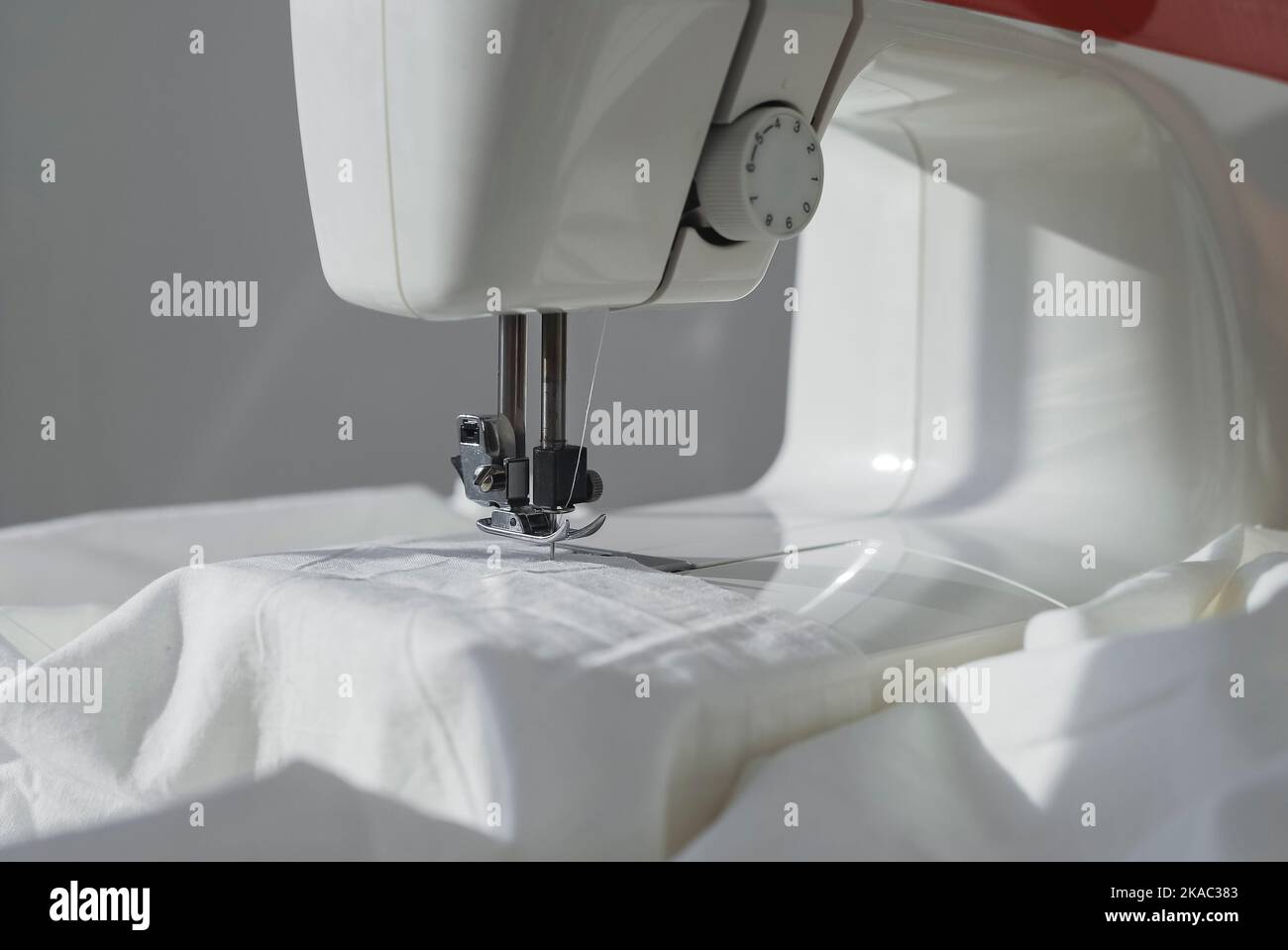 White cotton cloth on sewing machine close up Stock Photo - Alamy