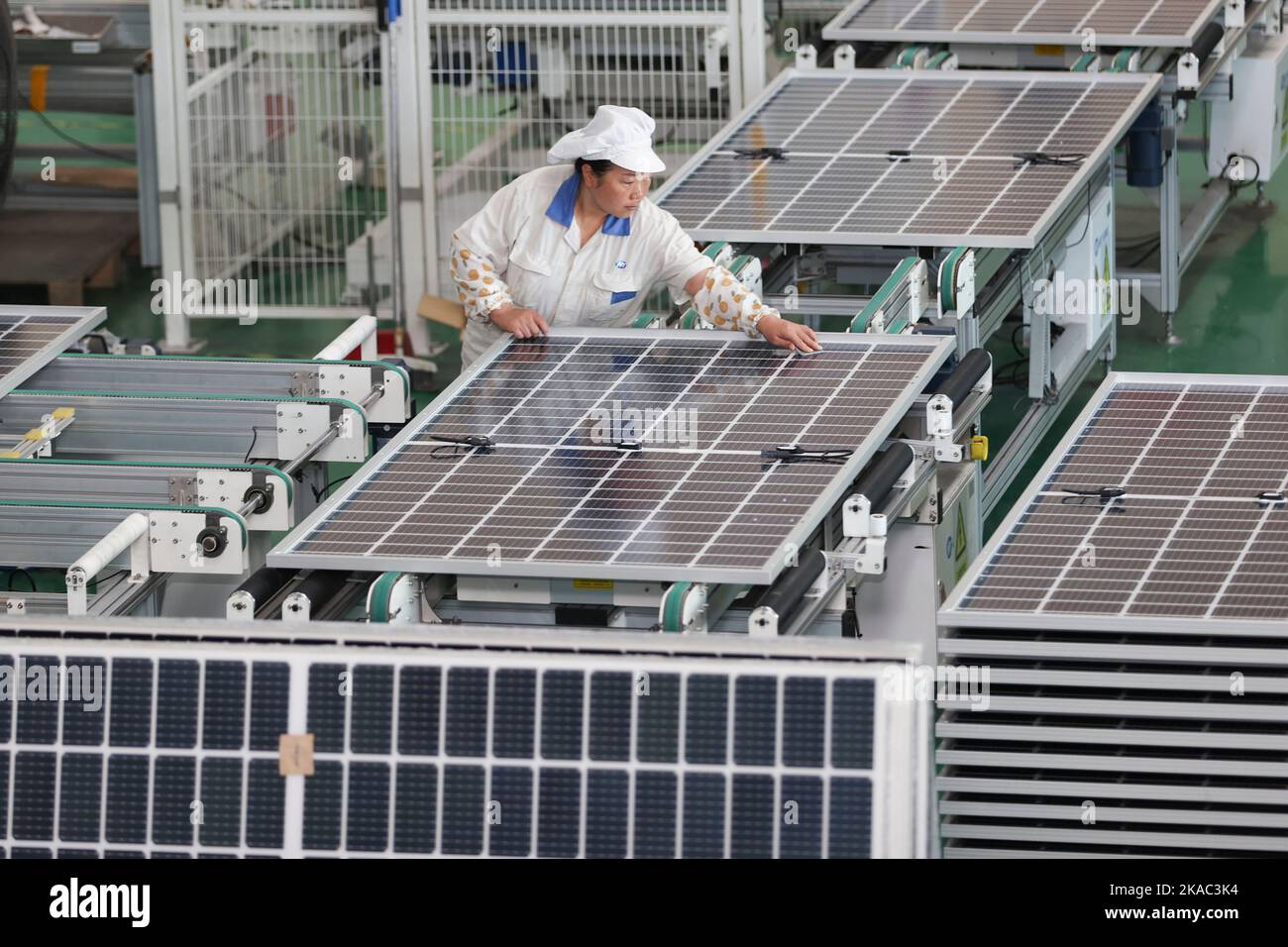 Workers are busy manufacturing the export solar photovoltaic panels in ...