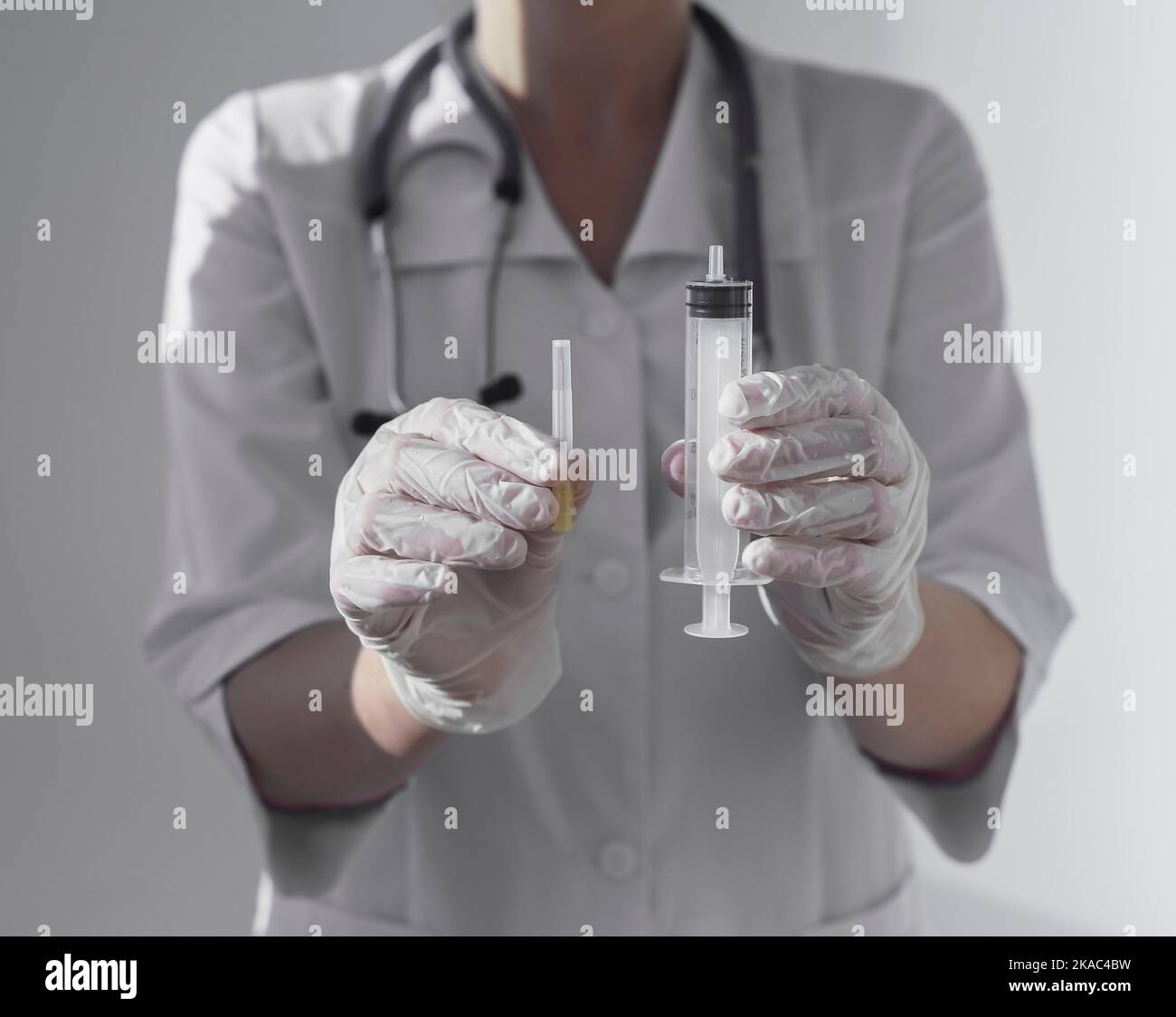 Syringe and needle in doctors or nurse hands, giving it toward Stock ...