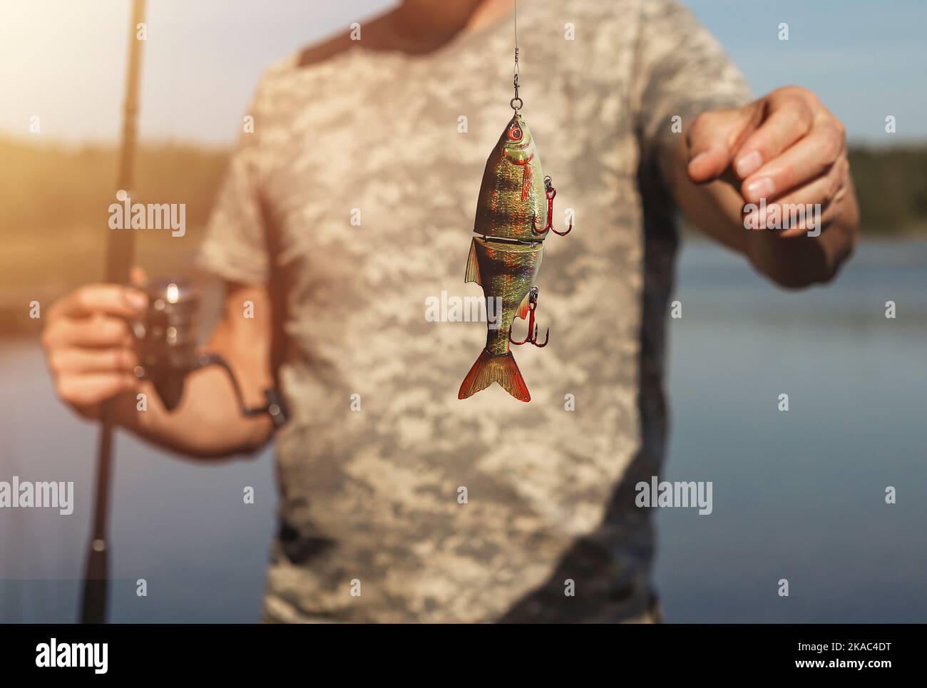 Minsk, Belarus October 30 2021 Swim bait or wobbler on fishing rod for ... Minsk, Belarus October 30 2021 Swim bait or wobbler on fishing rod for ...