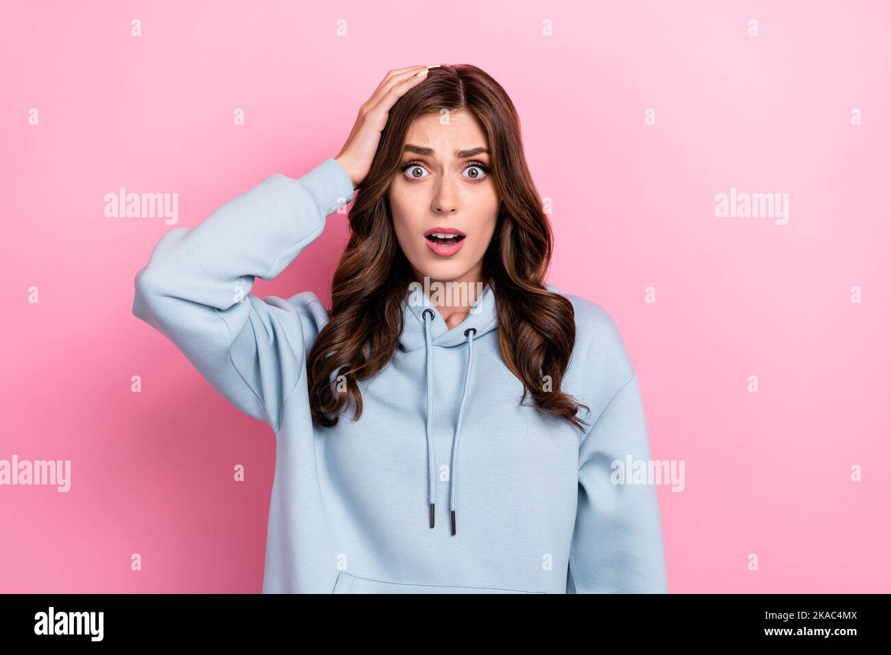 Photo of shocked pretty girl arm touch head staring cant believe ...