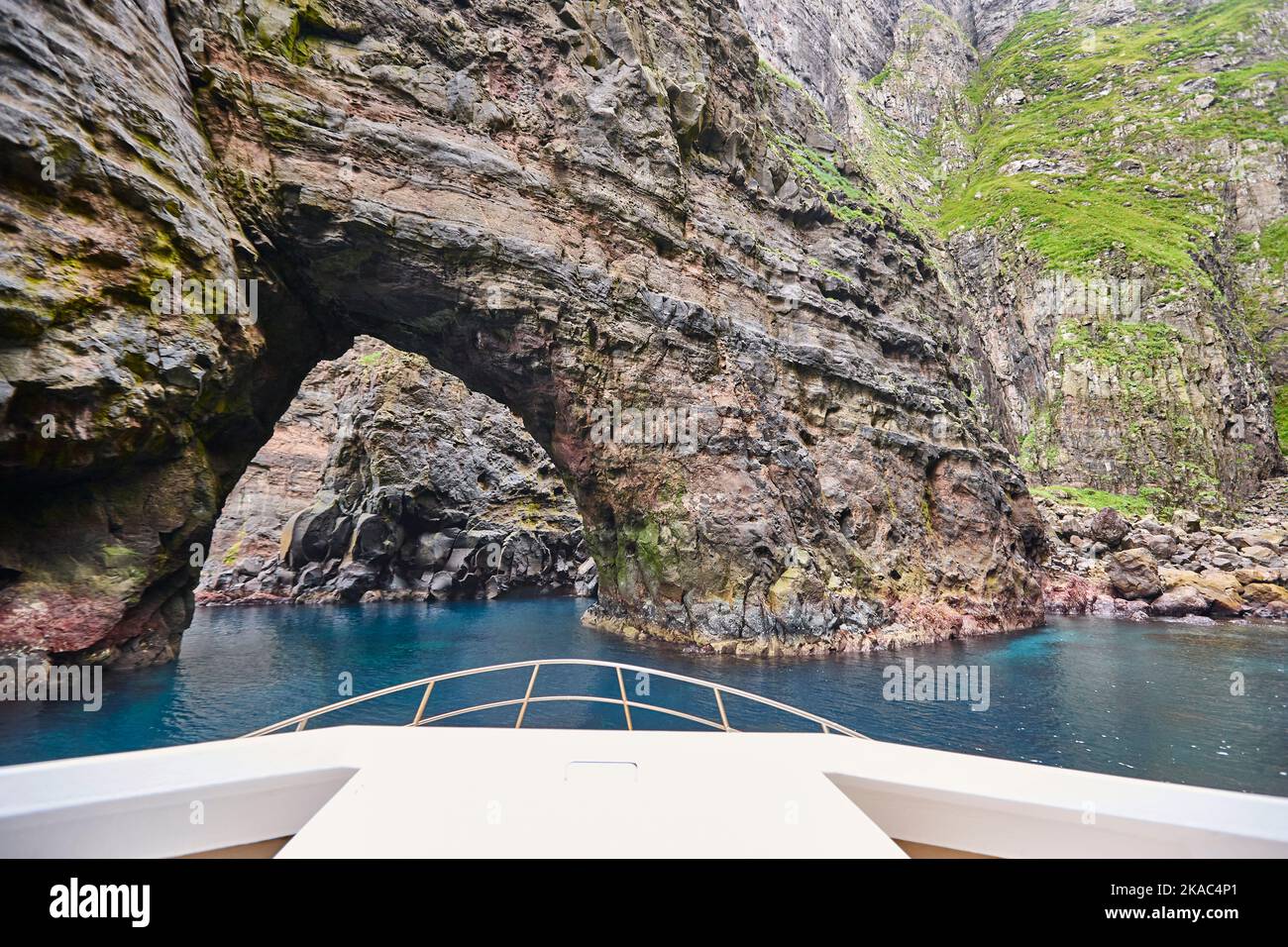 Stunning green cliffs and cave on atlantic ocean in Faroe islands Stock ...
