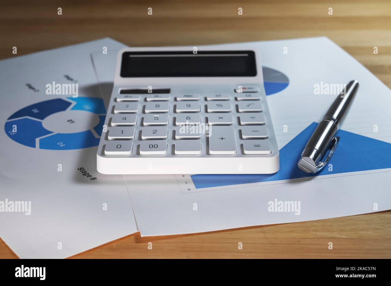 Calculator on business documents with blue charts. Accounting concept ...