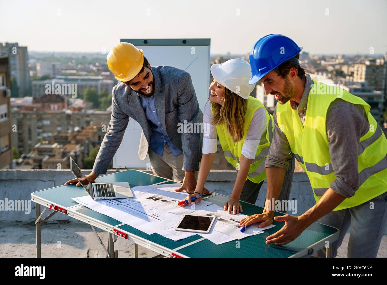 Group of engineers, architects, business partners at construction site ...