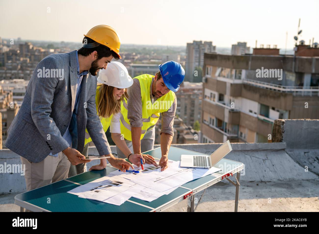 Construction concept. Engineers and architects working at construction site with blueprint Stock ...