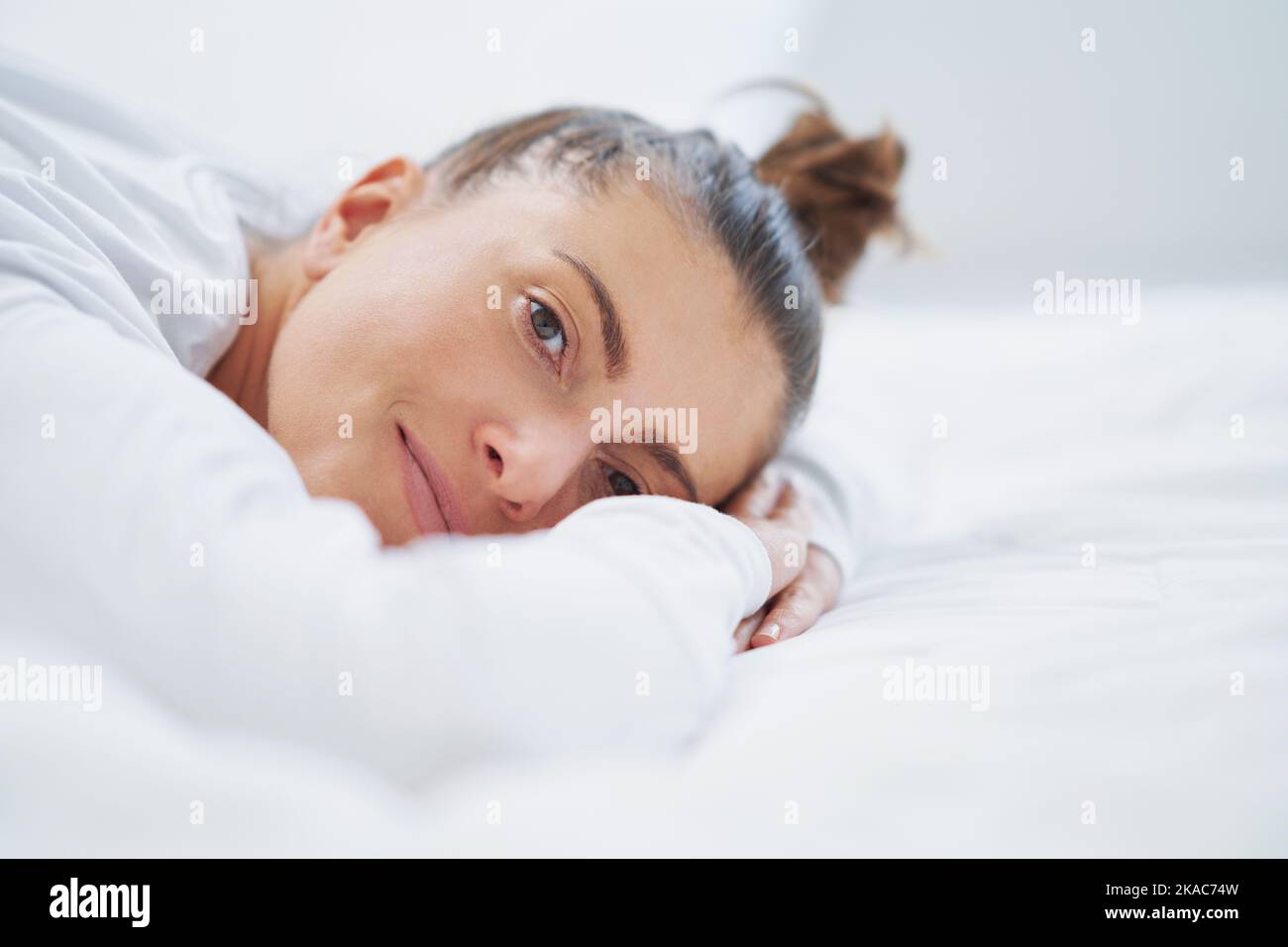 Nice female in bed relaxing or doing yoga Stock Photo - Alamy