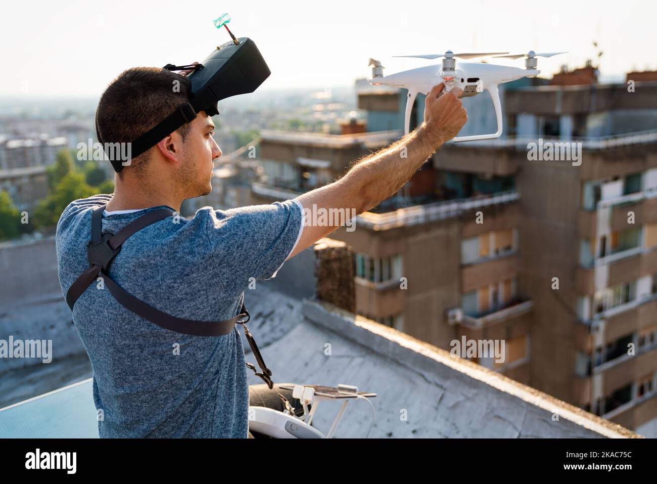 Man operating a drone with remote control on rooftop Stock Photo - Alamy