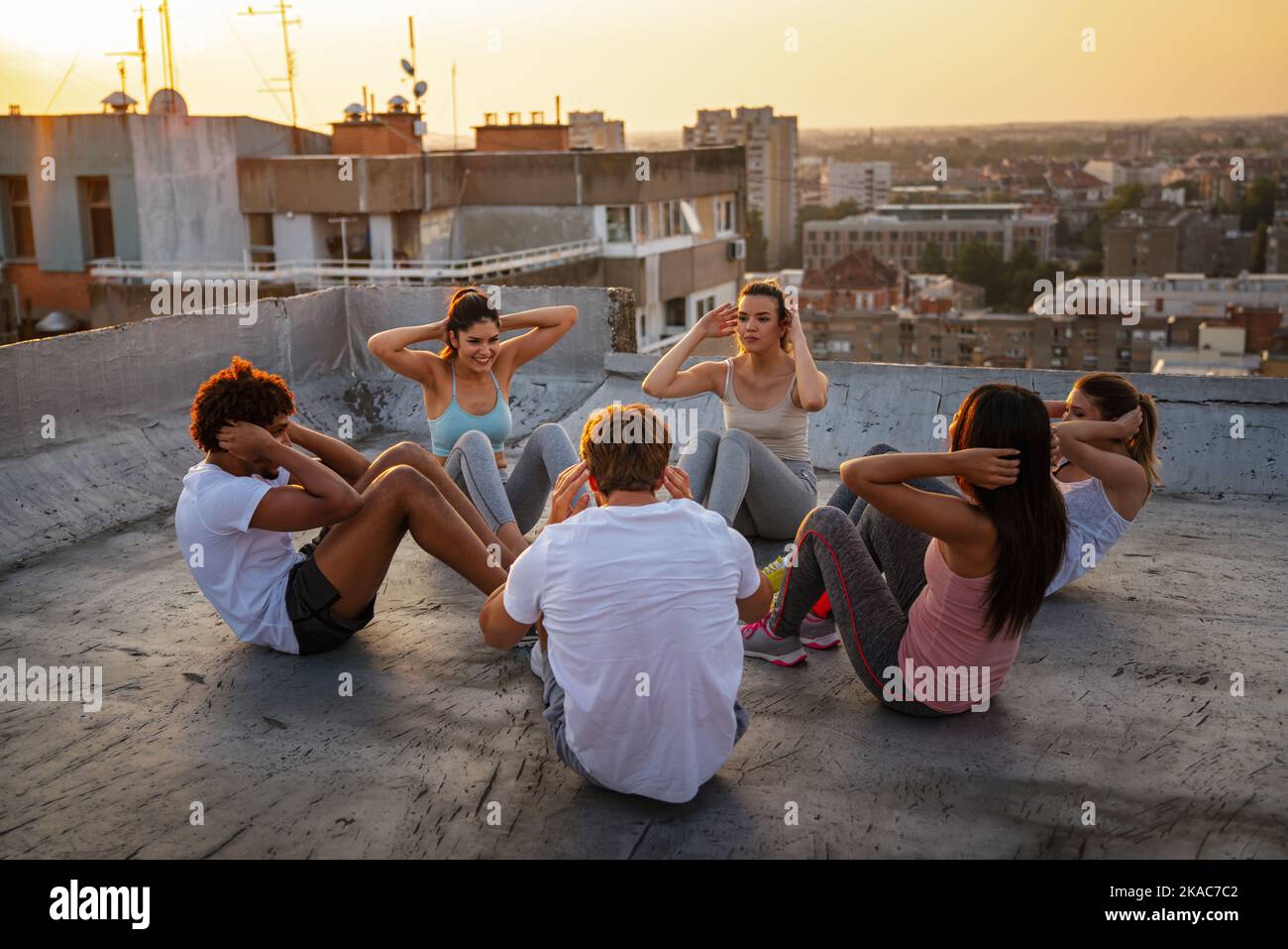 Group of happy fit people friends exercising together outdoor to stay ...