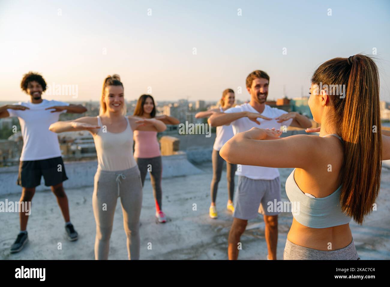 Group of happy fit people friends exercising together outdoor to stay ...