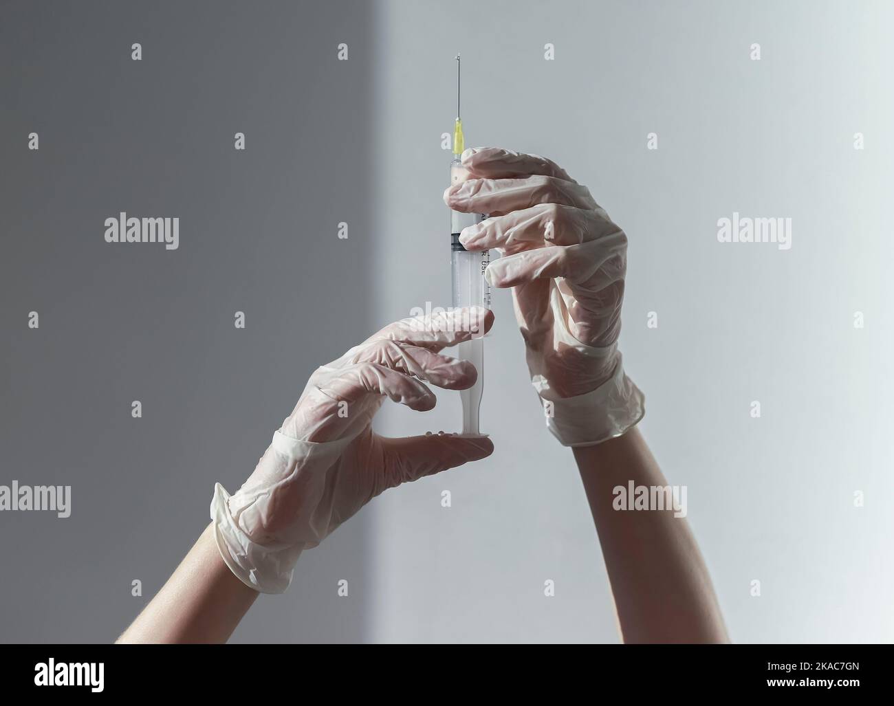 Syringe with needle in doctors hands in white gloves Stock Photo - Alamy