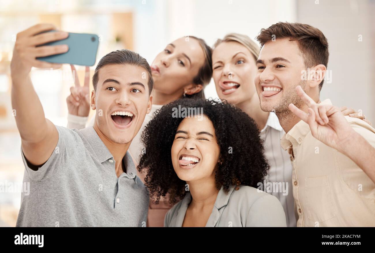 Phone, selfie and work friends with funny faces at team building event or meeting in office ...