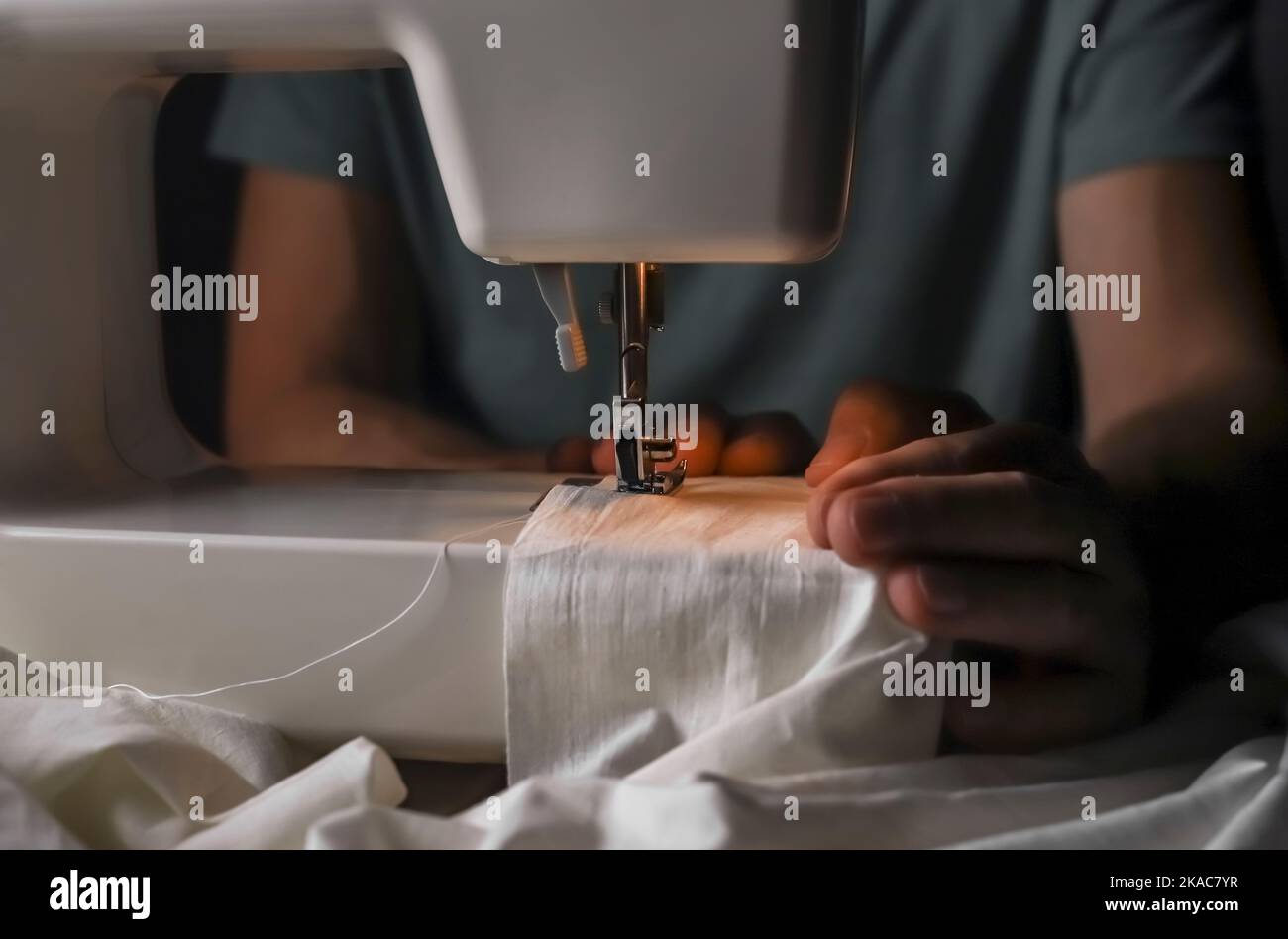 Male hands making stitch on textile on sewing machine Stock Photo - Alamy