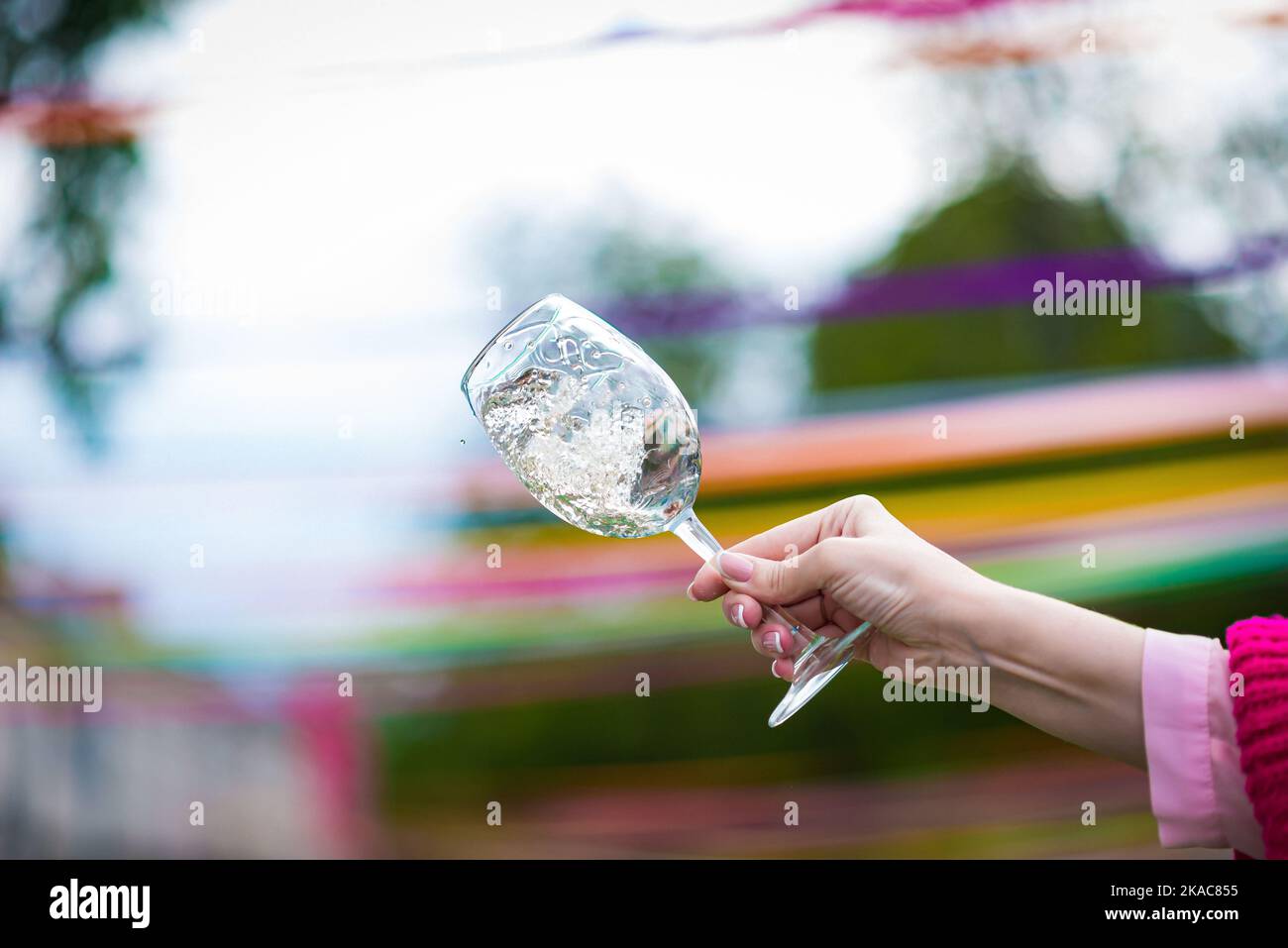 People clinking glasses with wine on the summer terrace of cafe or ...