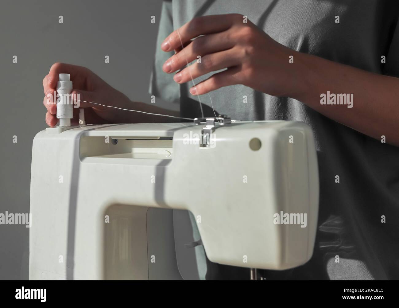 Female hands sewing on modern hi-res stock photography and images - Alamy