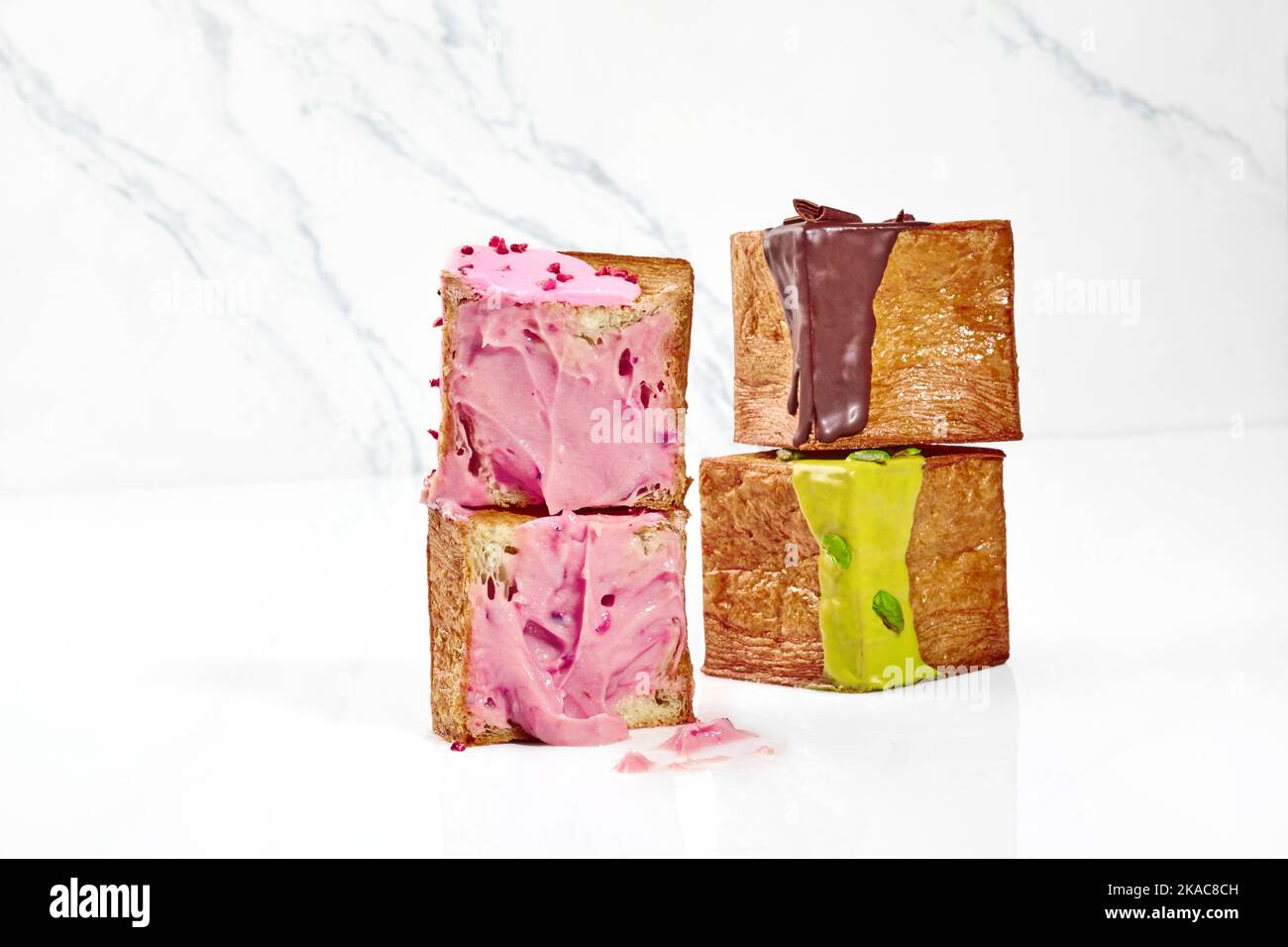 Sliced puff cube croissant with berry cream and two whole cubes with ...