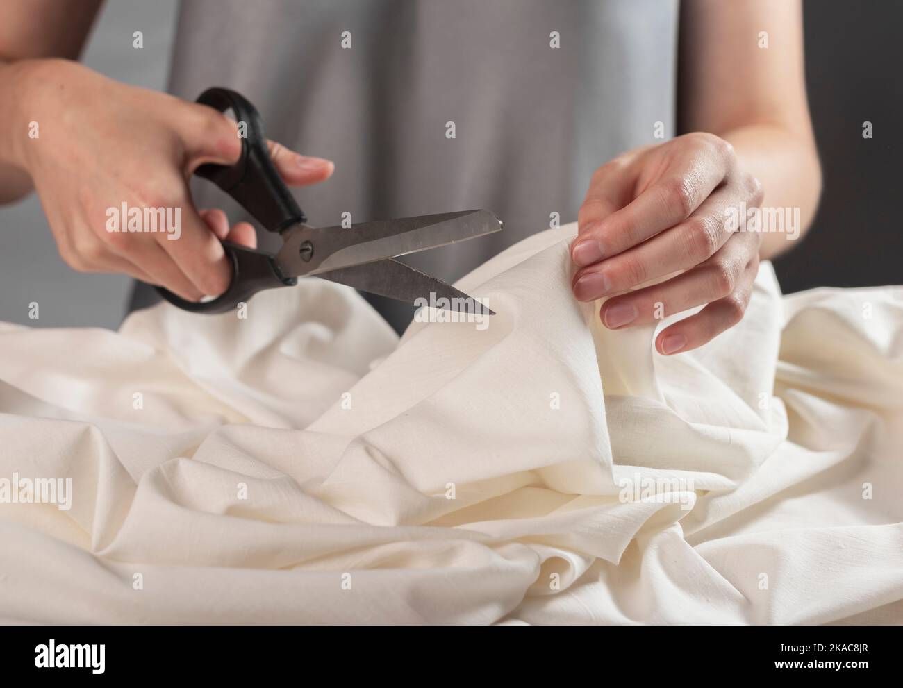 Seamstress cutting cloth with scissors. Dressmaker close up Stock Photo ...