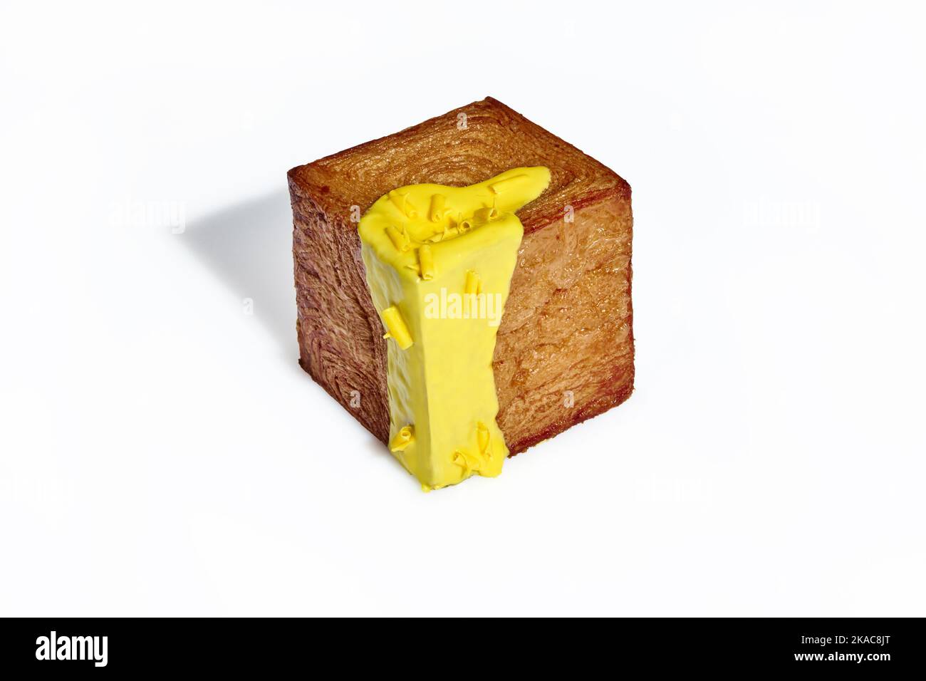Freshly baked whole toasted cubic croissant topped with yellow colored ...