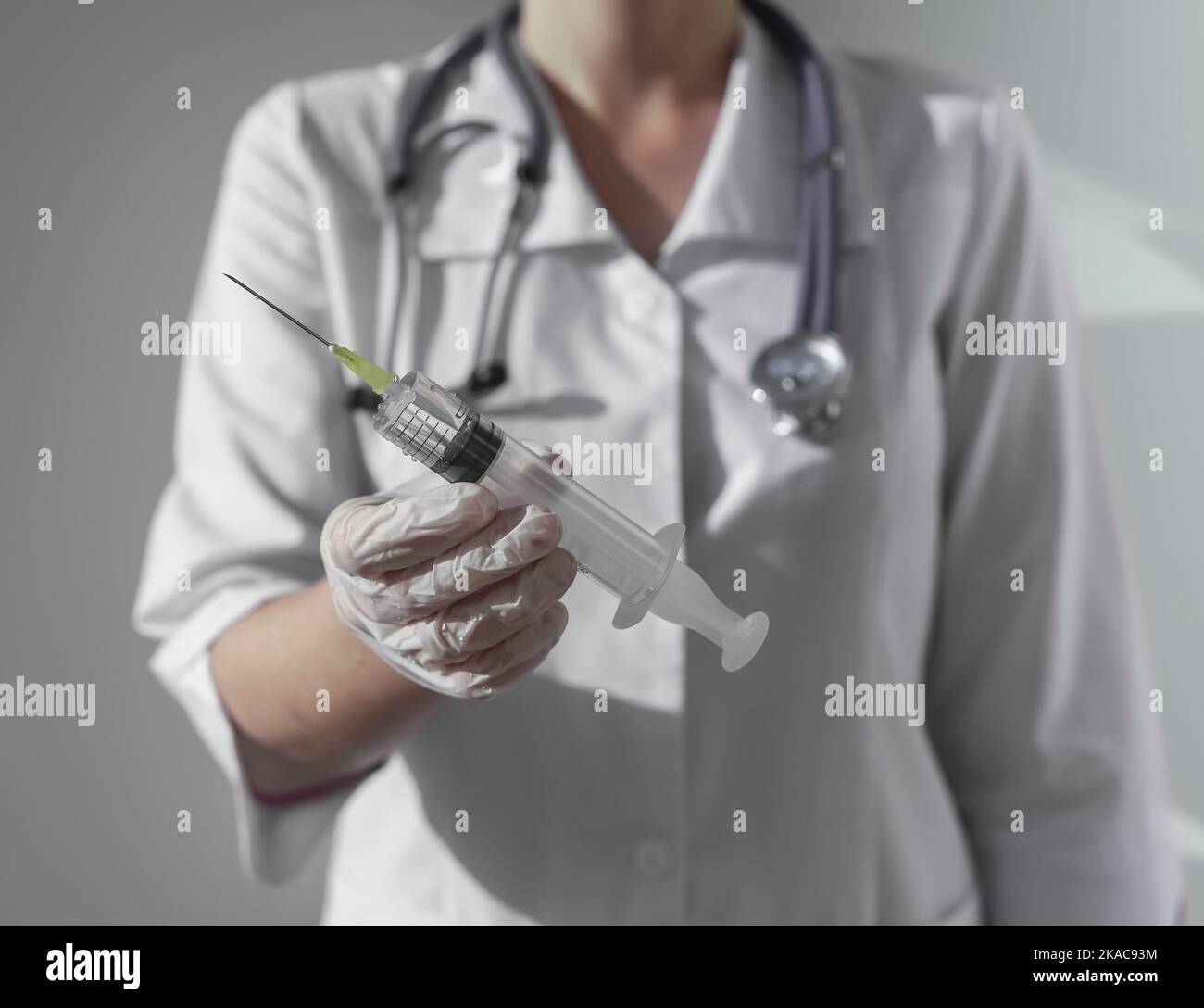 Plastic syringe with sharp needle and liquid inside in doctors or nurse ...