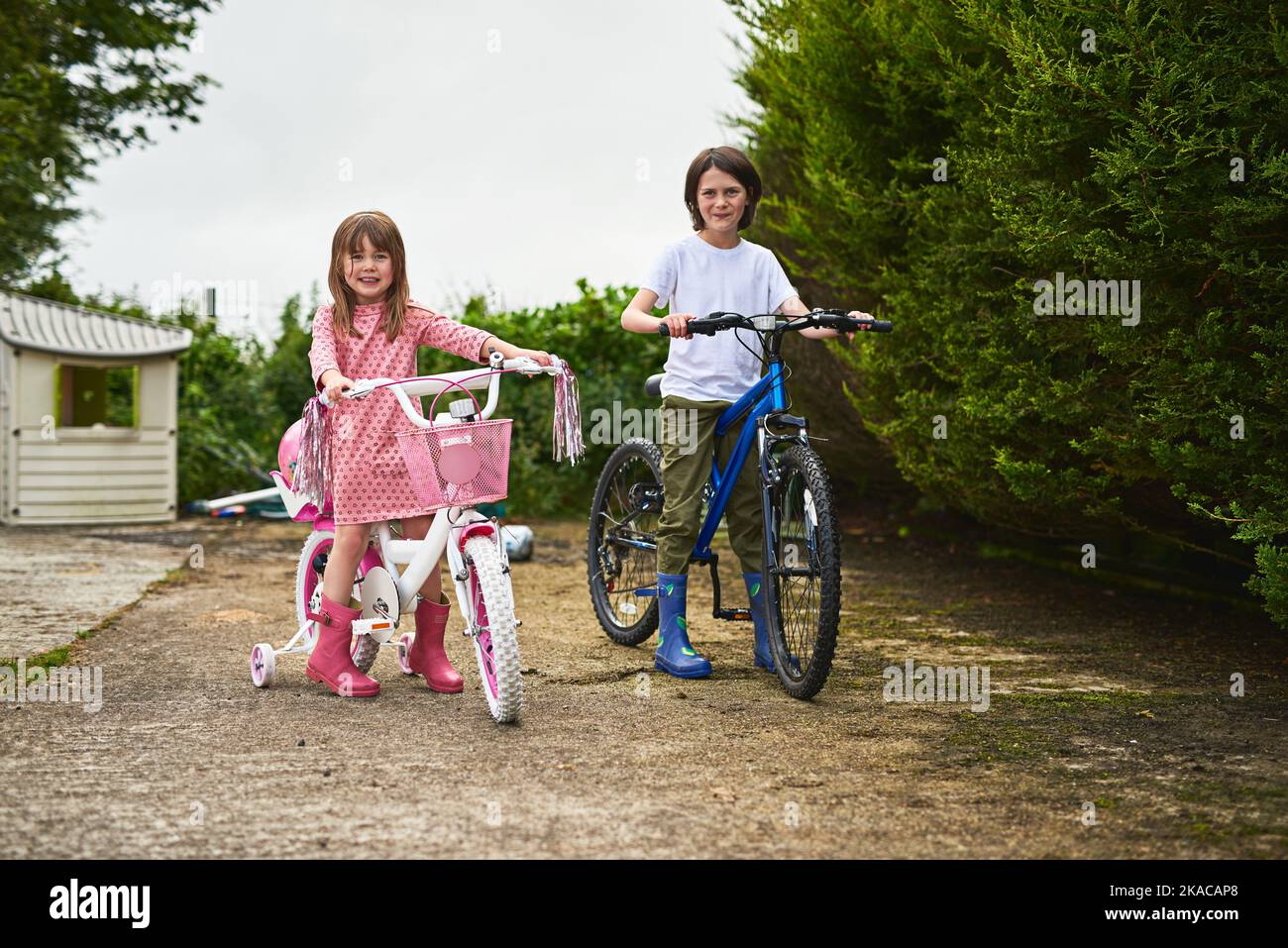 Come ride with us. Portrait of two little siblings riding their bikes ...