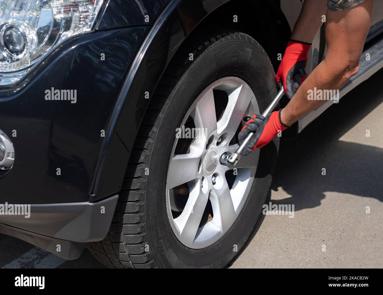 Fixing and checking wheel tire of car with manual tool, closeup Stock ...