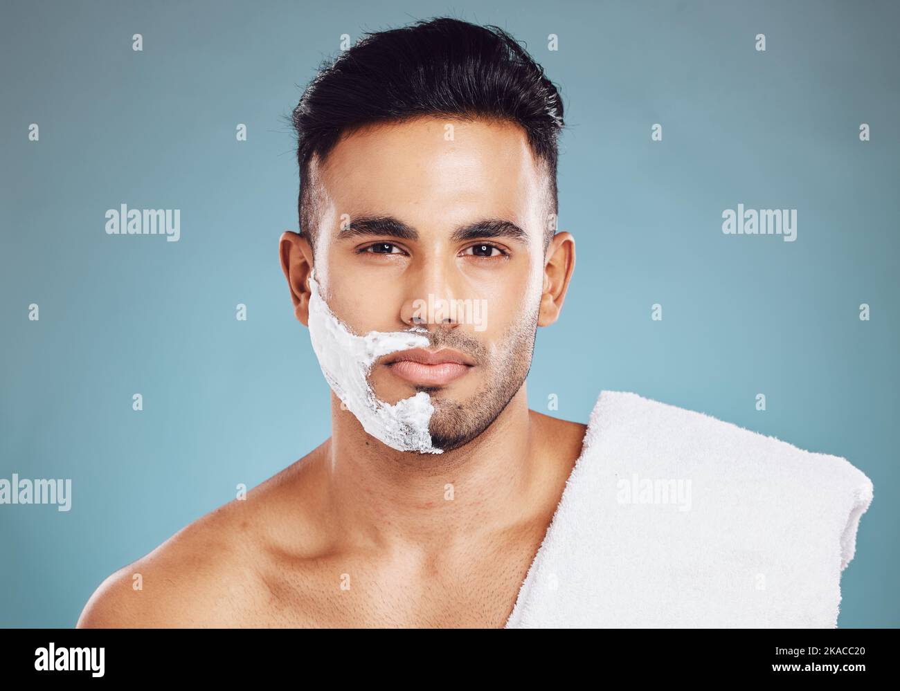 Shaving, beard and man with cream on his face for skincare against a blue mockup studio ...